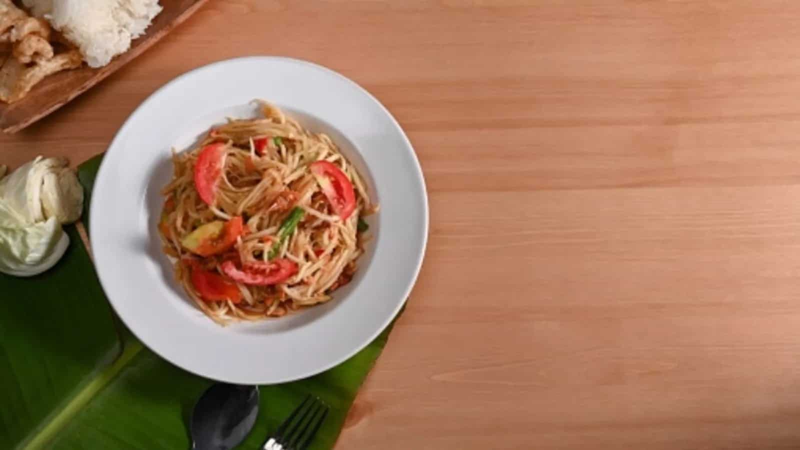Merge healthy and tasty with raw papaya salad. Recipe inside
